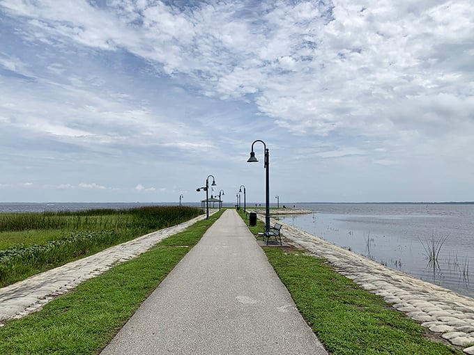 East Lake Tohopekaliga stretches out like a mirror to the sky, where lamp-lit paths invite wanderers to stroll between two worlds.