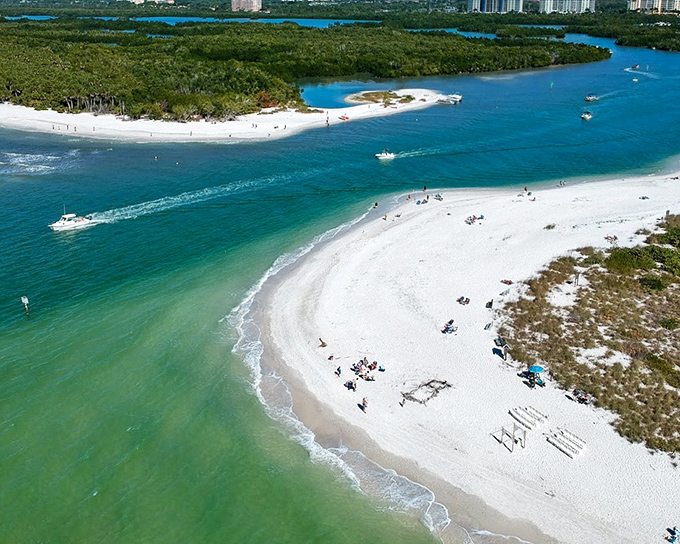 Aerial paradise: Delnor-Wiggins Pass State Park's pristine shoreline curves like nature's smile, where turquoise waters meet powdery white sands.