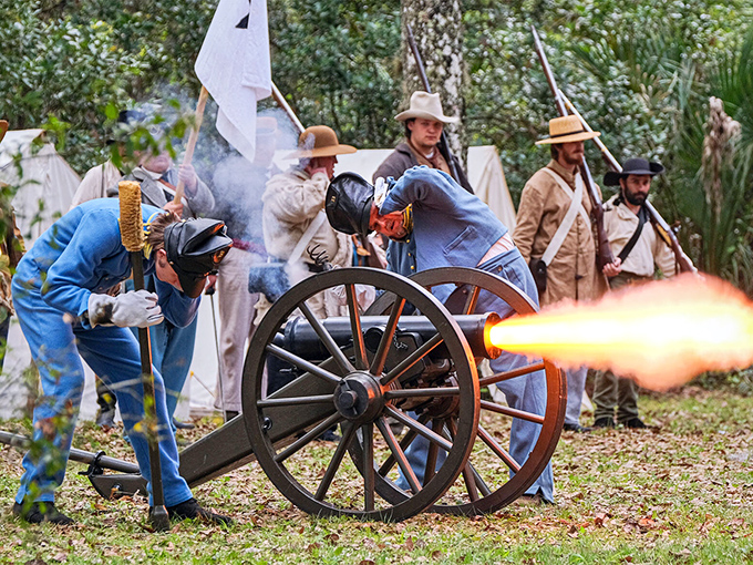 History erupts in spectacular fashion as reenactors fire a cannon, sending smoke billowing and hearts racing across centuries.