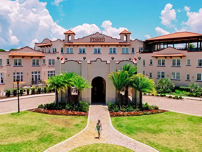 The Fenway Hotel stands like a pink Mediterranean dream against Florida's blue sky, promising rooftop adventures for those in the know.
