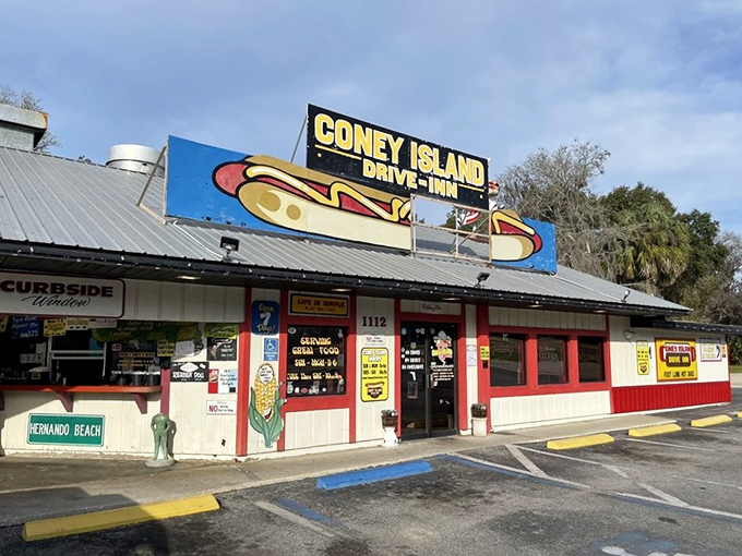 The iconic Coney Island Drive-Inn exterior beckons with its giant hot dog sign, promising a nostalgic journey into Florida's tastiest time capsule.