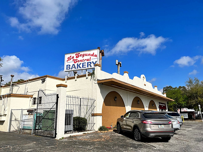 The iconic cream-colored exterior of La Segunda Central Bakery stands as a beacon of Cuban culinary tradition in Ybor City.