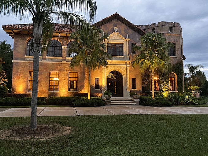 Twilight transforms the Howey Mansion into a golden vision of 1920s splendor, palm trees standing guard like elegant sentinels.