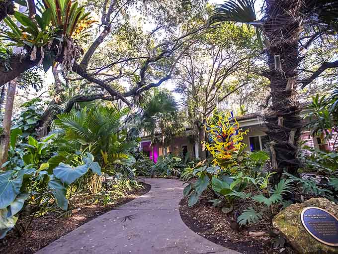 Fairchild's tranquil pond creates nature's perfect mirror, where palm reflections dance with fountain spray in a choreographed aquatic ballet.