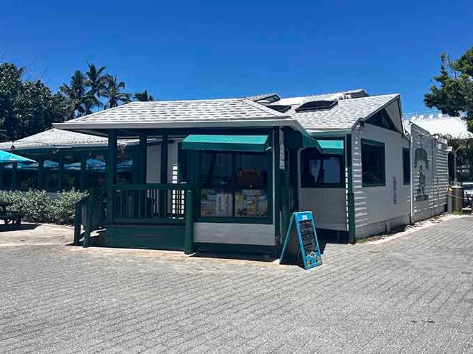 The Mucky Duck sits right on Captiva's sand like it grew there naturally, all turquoise trim and beach-shack charm waiting to feed you.