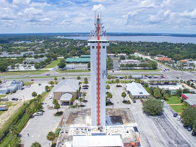 The Florida Citrus Tower stands tall against the blue Florida sky, a white and orange sentinel guarding memories of the state's agricultural golden age.