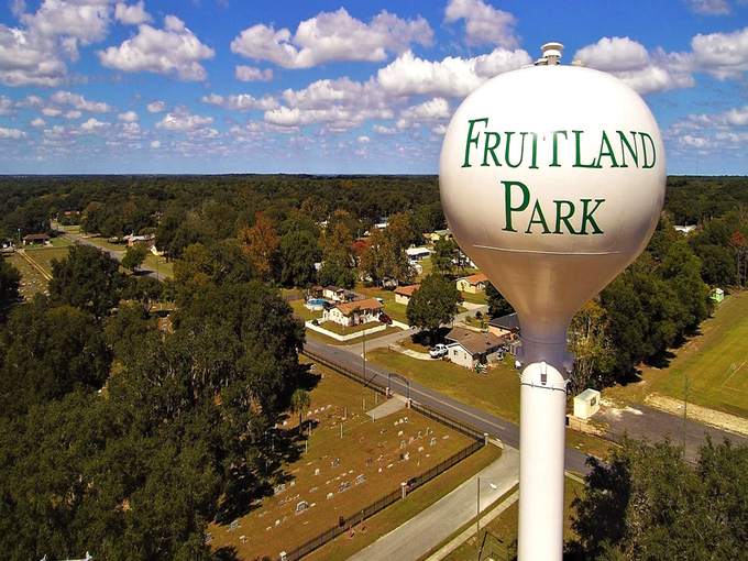 The iconic Fruitland Park water tower stands tall against Florida's blue sky, welcoming visitors to this charming small town oasis.