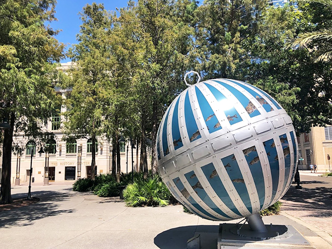 The "Global Convergence" sculpture stands proudly in downtown Orlando, its blue and silver surfaces gleaming in the Florida sunshine like an oversized holiday ornament.