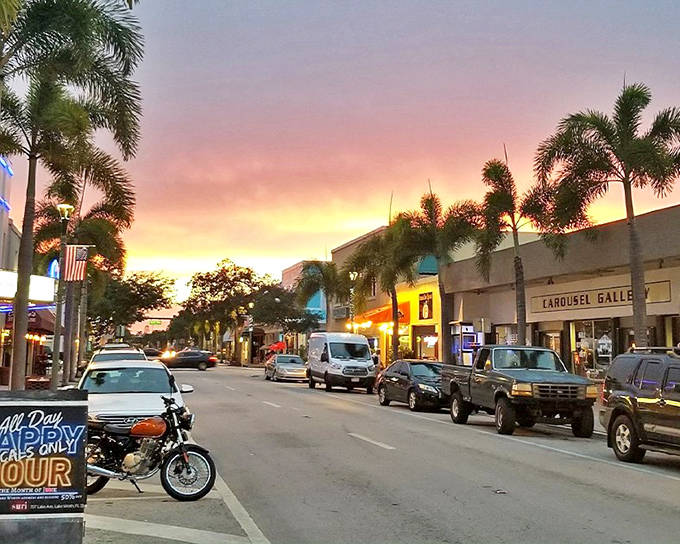 Lake Worth's main drag at sunset &ndash; where palm trees stand guard over streets that buzz with local energy and charm.