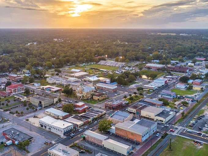 Aerial view of Live Oak at sunset, where small-town charm meets golden hour magic across the historic downtown landscape.