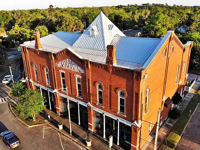 The majestic red-brick facade of Monticello Opera House stands proudly against the Florida sky, its pyramid-topped roof a beacon of cultural heritage.