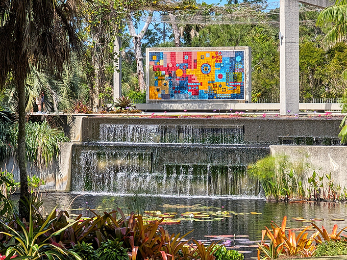 A vibrant mosaic mural creates a stunning backdrop for cascading waters &ndash; nature and art performing their daily duet.