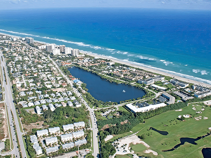 Aerial paradise: Where turquoise Atlantic waves meet a serene freshwater oasis, Pelican Lake creates nature's perfect sandwich with Juno Beach as the filling.