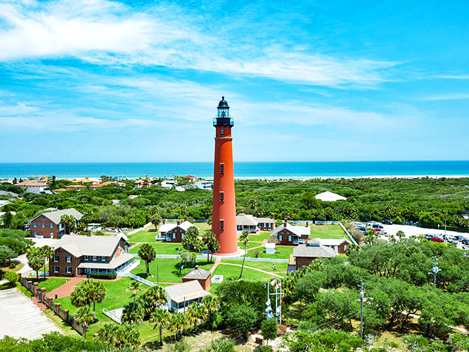 The majestic Ponce De Leon Inlet Lighthouse stands tall against the Florida sky, its brick-red tower a beacon of maritime history and adventure waiting to be climbed.