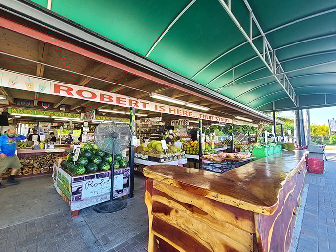 The iconic green-roofed fruit stand beckons with its rustic charm and promise of tropical treasures waiting inside.