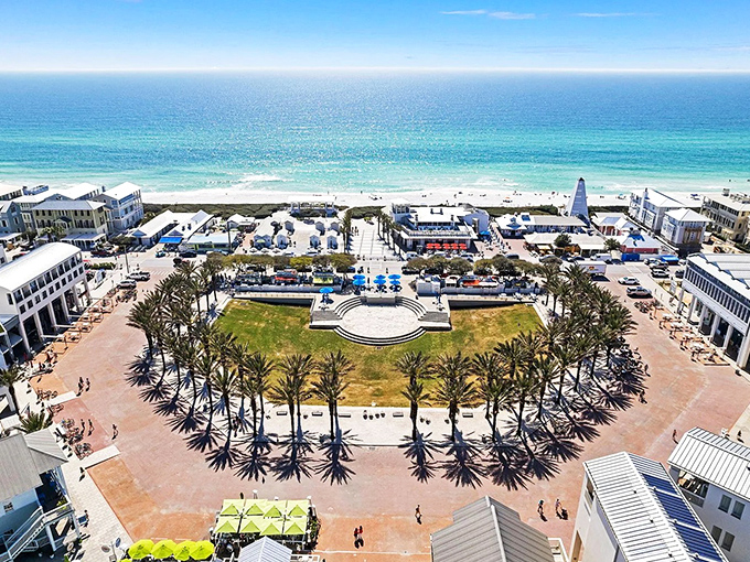 Seaside's central square unfolds like a pastel-colored dream, where palm trees stand at attention and the Gulf beckons just beyond.