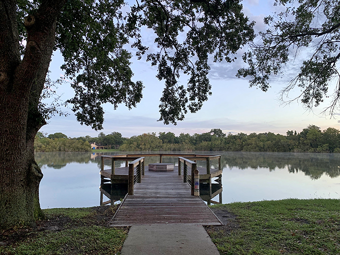 A wooden dock stretches into the mirror-like waters of Secret Lake Park, where tranquility isn't just promised&mdash;it's delivered.