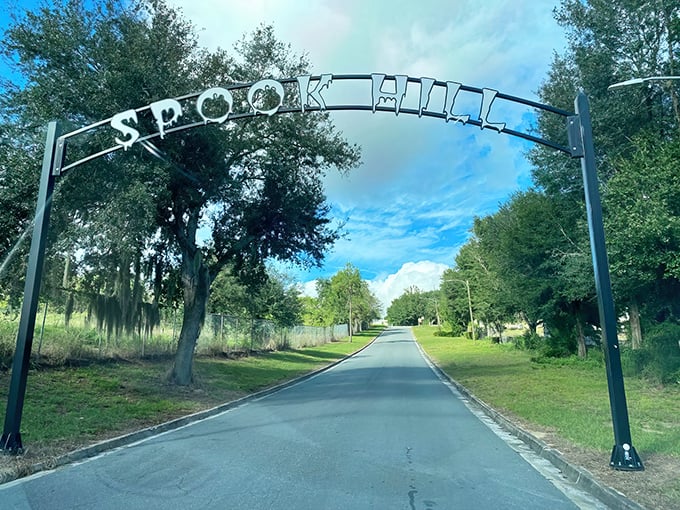 The iconic Spook Hill archway welcomes visitors to Florida's gravity-defying mystery &ndash; where physics takes a vacation and cars roll uphill.