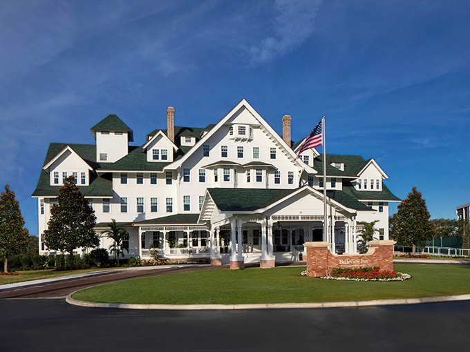 The Belleview Inn stands majestically against the Florida sky, its pristine white facade and green roof channeling Gatsby-era glamour with a tropical twist.