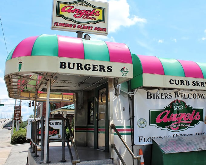 The iconic pink and green awning of Angel's Diner stands out like a retro beacon, promising delicious nostalgia inside.
