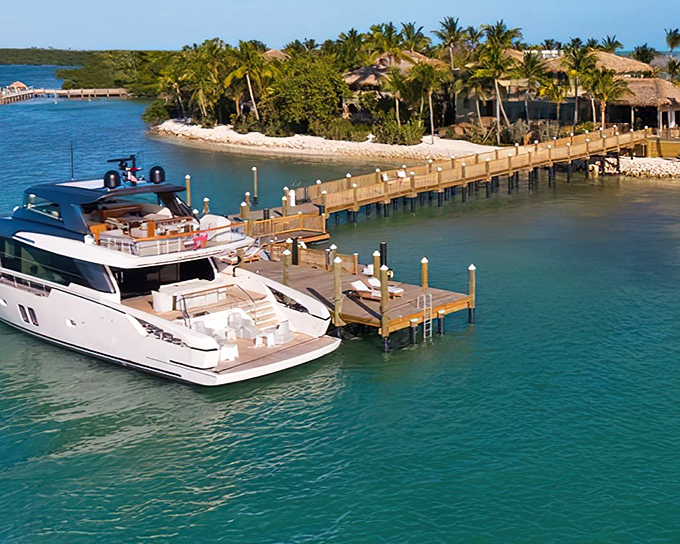 A luxury yacht approaches Little Palm Island's wooden dock &ndash; where your worries are required to stay behind on the mainland.