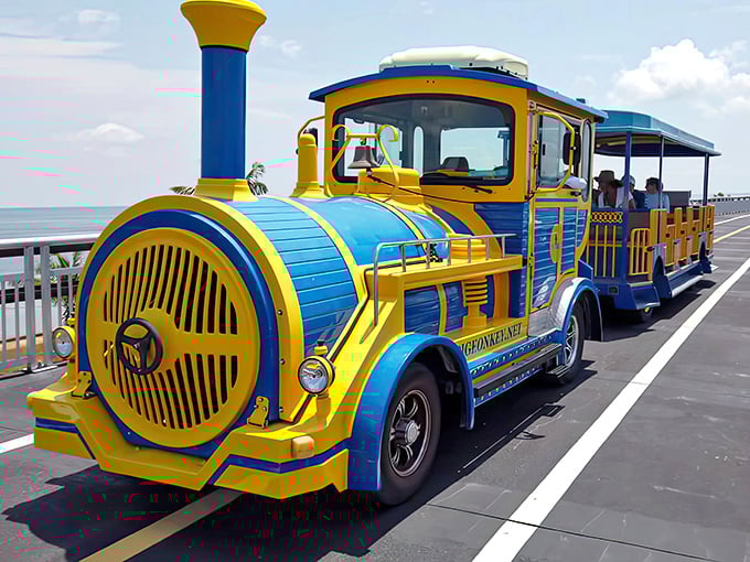 The Pigeon Key Express gleams in vibrant yellow and blue, a cheerful time machine ready to transport visitors across the sparkling Florida waters.