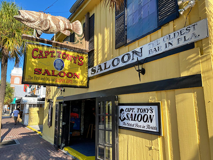 The sunshine-yellow facade of Captain Tony's Saloon stands out like a tropical beacon, promising cold drinks and warm stories inside.