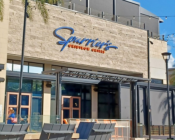 Exterior: Spurrier's bold blue signage pops against the neutral stone facade, promising a dining experience that's anything but ordinary.
