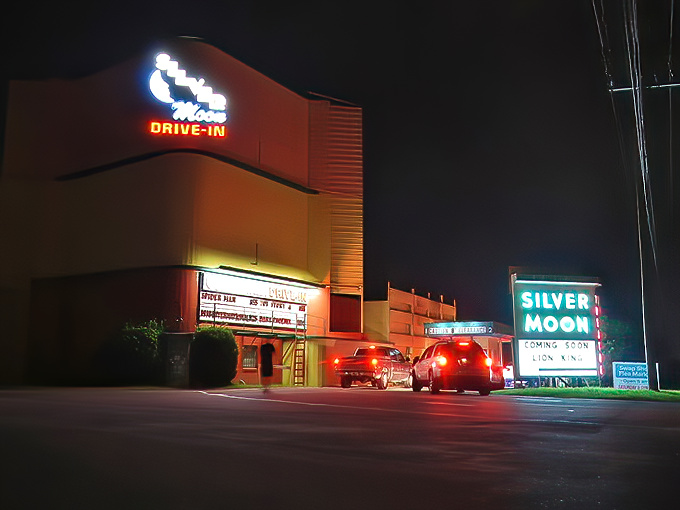 The iconic Silver Moon Drive-In sign glows against the night sky, a neon beacon calling movie lovers to Lakeland's vintage entertainment treasure.