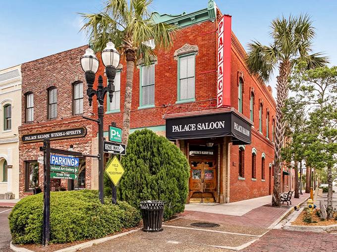 The iconic red brick exterior of the Palace Saloon stands proudly on Centre Street, its vintage signage and palm trees creating a perfect Florida time capsule.