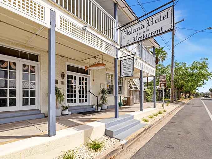 The Island Hotel stands proud on Cedar Key's main street, looking exactly like a building that's been greeting visitors since before your great-great-grandparents were born.