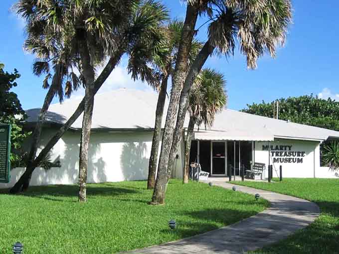 The unassuming exterior hides centuries of maritime drama, proving that the best treasures often come in modest packages beneath swaying palms.