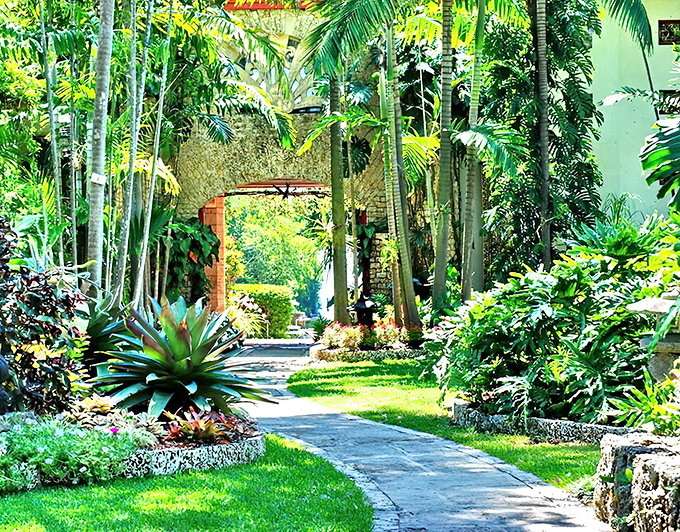 A verdant archway at The Kampong invites visitors into what feels like a secret tropical realm hidden within Miami's urban landscape.