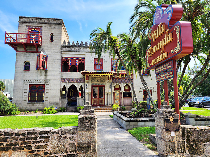 The iconic yellow Conch Tour Train glides past palm trees and historic buildings, a moving postcard of Key West's tropical charm.