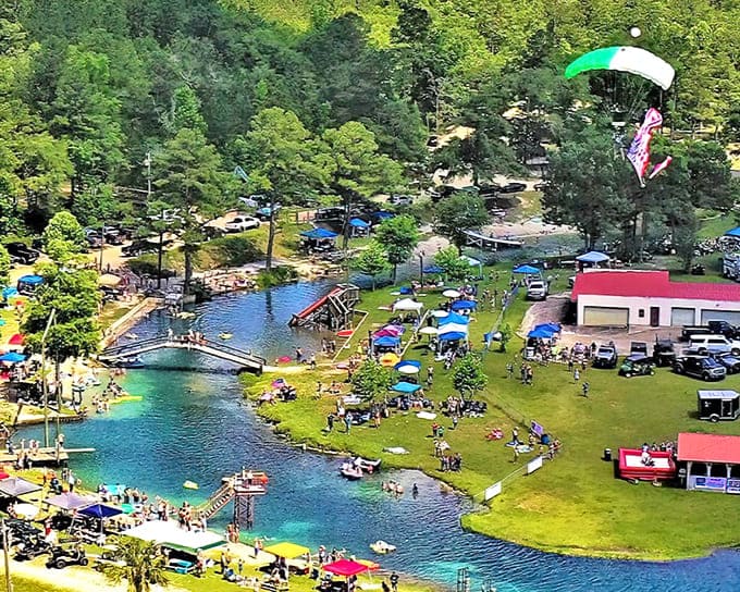 Aerial view of Vortex Spring's impossibly blue waters, where parachuters occasionally drop in for the ultimate entrance to this aquatic playground.