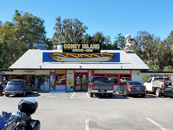 The iconic Coney Island Drive-Inn exterior stands proudly against the Florida sky, its vintage sign promising hot dog heaven since 1960.