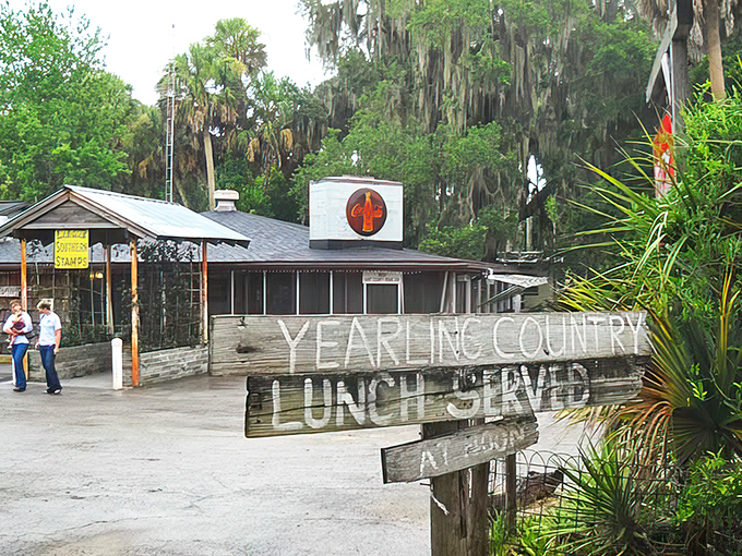 The rustic exterior of The Yearling Restaurant beckons hungry travelers with its weathered charm and promise of authentic Florida cuisine.