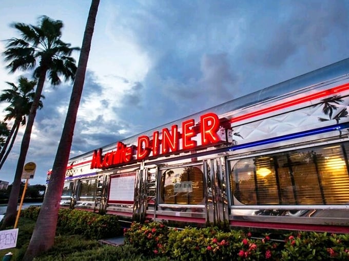 Moonlite Diner's gleaming silver exterior and vibrant red neon sign create the perfect time-travel portal to 1950s Americana in Fort Lauderdale.