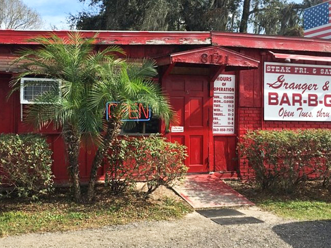 The iconic red exterior of Granger & Sons beckons hungry travelers with promises of smoky delights and Southern hospitality.