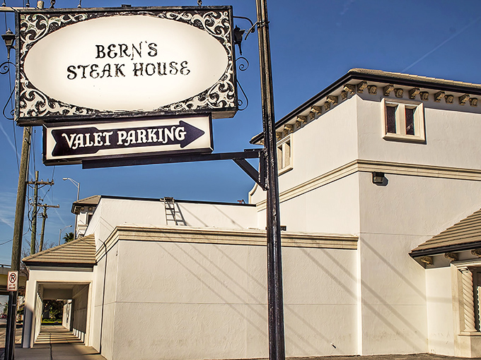 The iconic Bern's Steak House sign stands sentinel on Tampa's Howard Avenue, promising carnivorous delights with a side of old-world elegance.