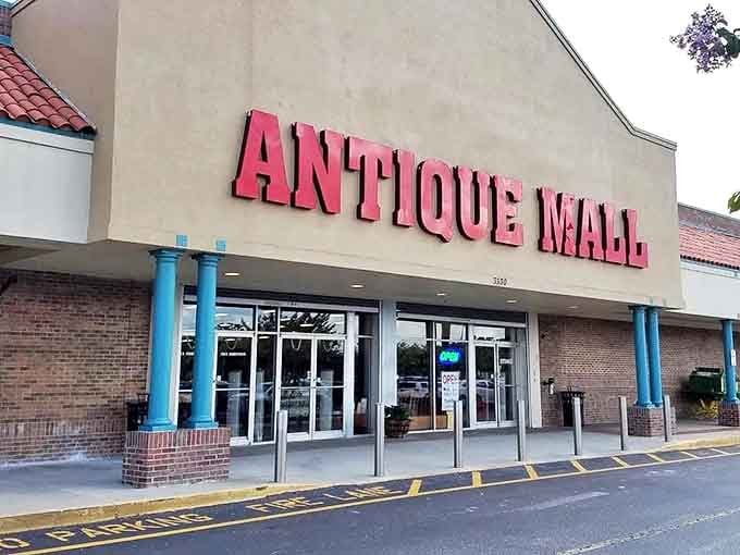 The bold red "ANTIQUE MALL" sign beckons treasure hunters like a vintage Vegas marquee, promising wonders within those unassuming walls.