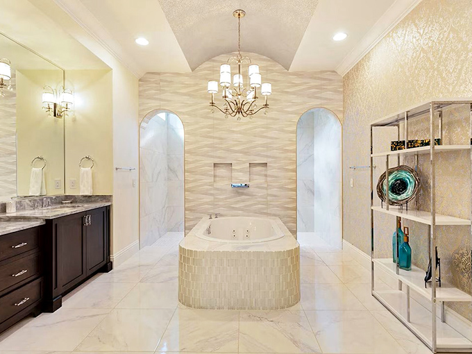 Bubble bath, anyone? This spa-like sanctuary with dual shower entrances and chandelier lighting elevates self-care to an art form.