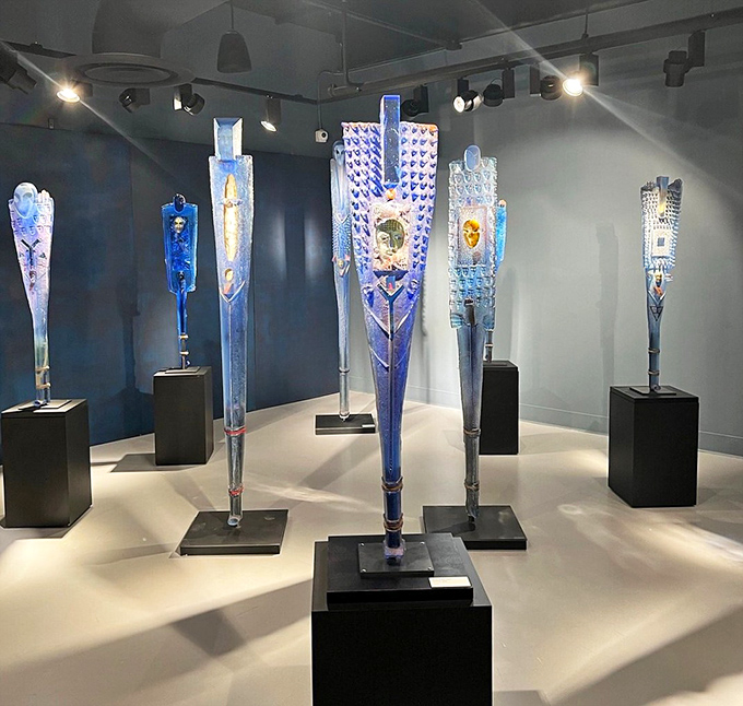 These blue totem-like sculptures reach skyward like ancient artifacts from a civilization that mastered both glass and spiritual expression.