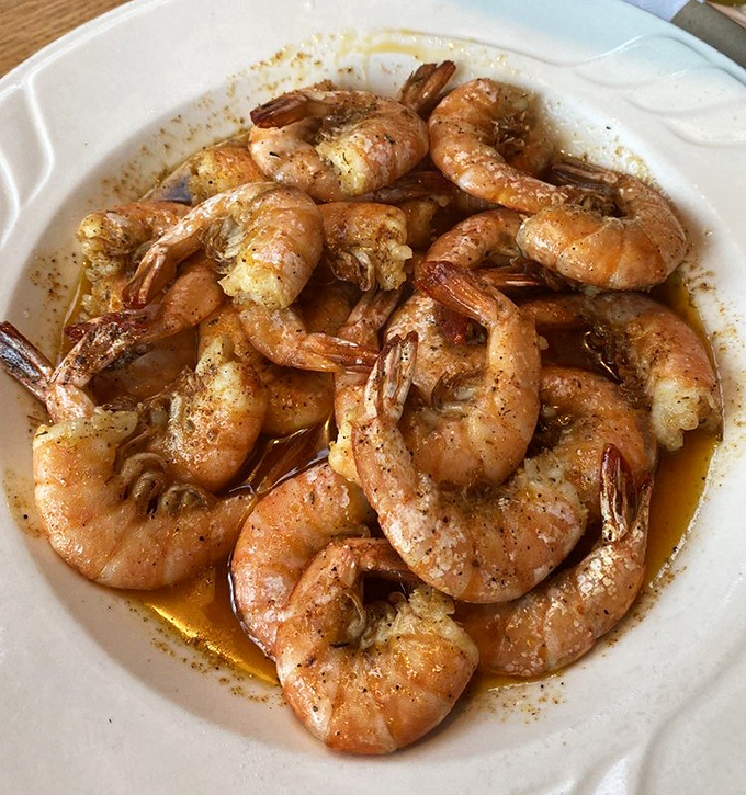 Cajun peel-and-eat shrimp swimming in spiced butter sauce – messy, delicious, and worth every napkin you'll need afterward.