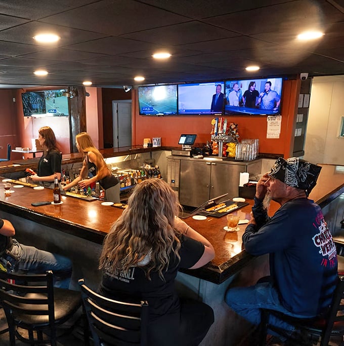 The bar area hums with conversation as patrons perch on stools, sharing stories and sports commentary between sips of cold beer.