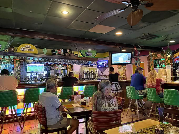 The bar area buzzes with energy as patrons gather for happy hour specials and lively conversation over colorful cocktails.