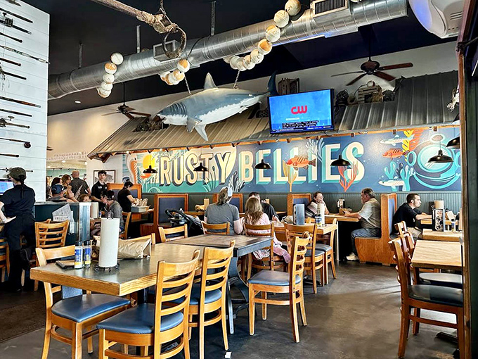 The dining room buzzes with conversation while nautical d&eacute;cor and that signature mural create the perfect coastal vibe.