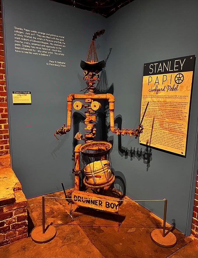 "Drummer Boy" keeps a rusty rhythm, his mechanical arms forever poised to strike his makeshift drum of salvaged metal.