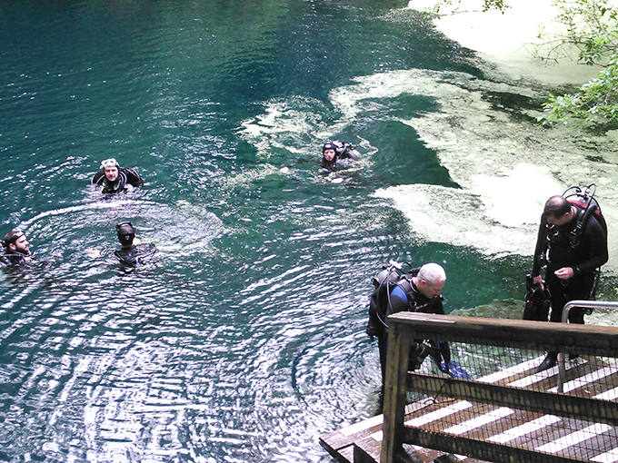 Weekend explorers follow ancient paths through Peacock Springs' verdant surroundings, unaware of the vast network flowing beneath their feet.