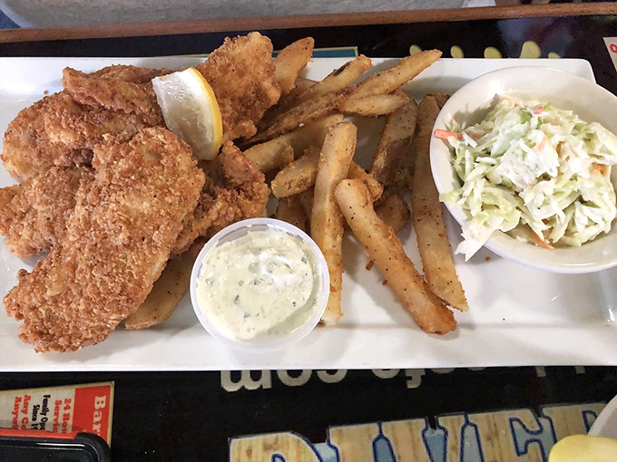 The fish and chips features local snapper in a golden batter so crisp it practically shatters, paired with fries that demand dunking.